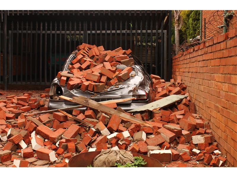 Bricks from block of flats' wall flatten car | Kempton Express