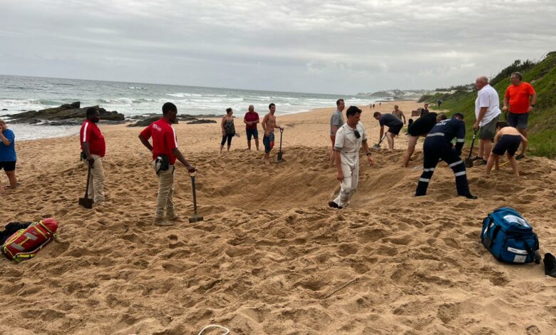Woman rescued after beach trench collapses, trapping her for an hour ...