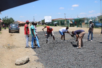Residents of eMbalenhle repair and maintain road to their clinic ...